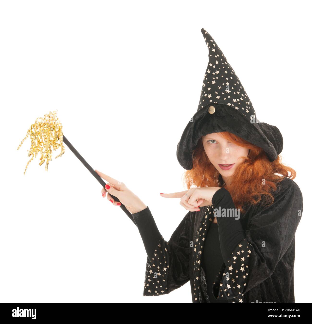 Young woman with red hair as evil witch isolated over white background ...