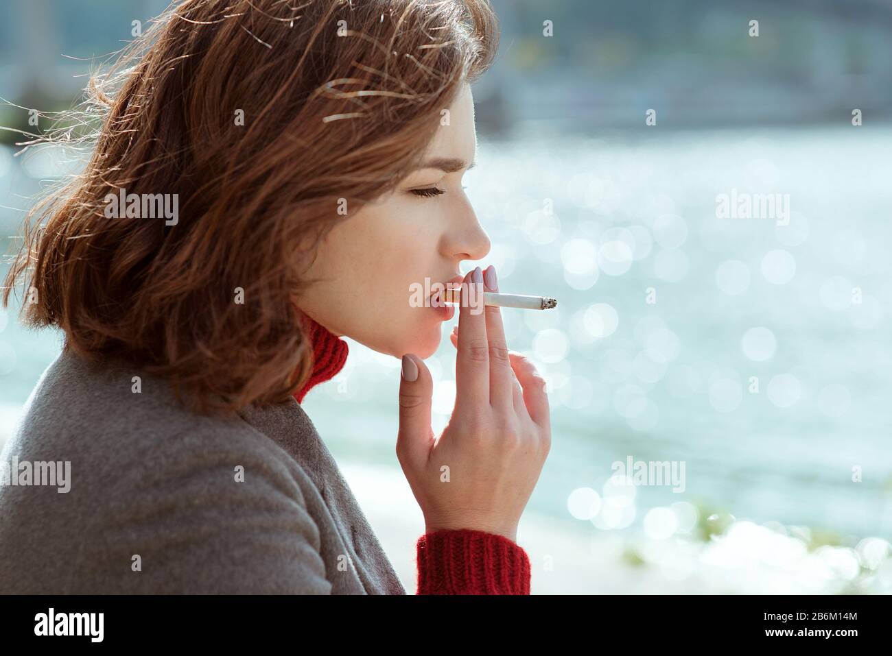 Close up woman lighting cigarette hi-res stock photography and images ...