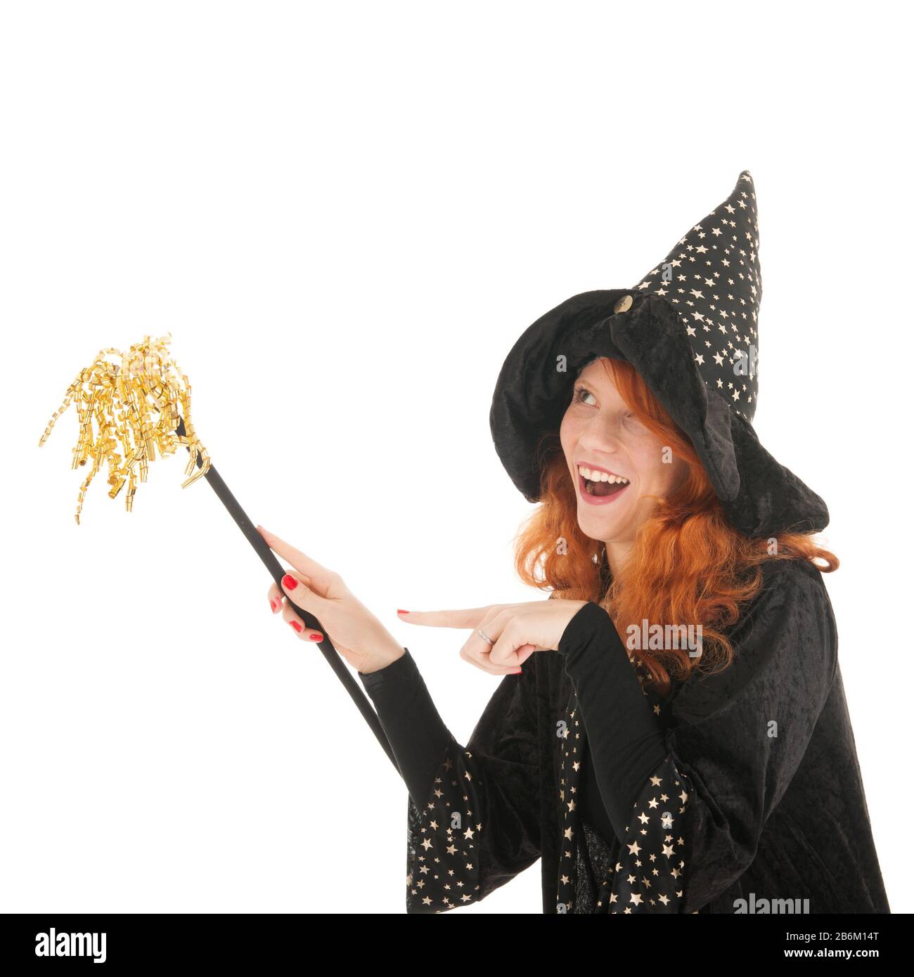 Young woman with red hair as evil witch isolated over white background ...