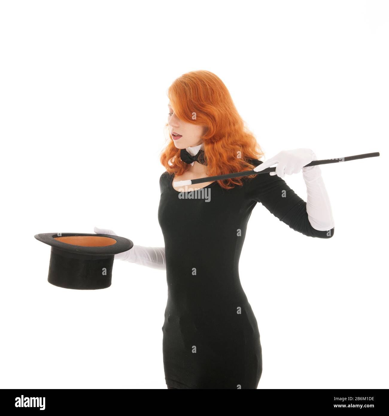 Woman conjuring with silk black hat Stock Photo - Alamy