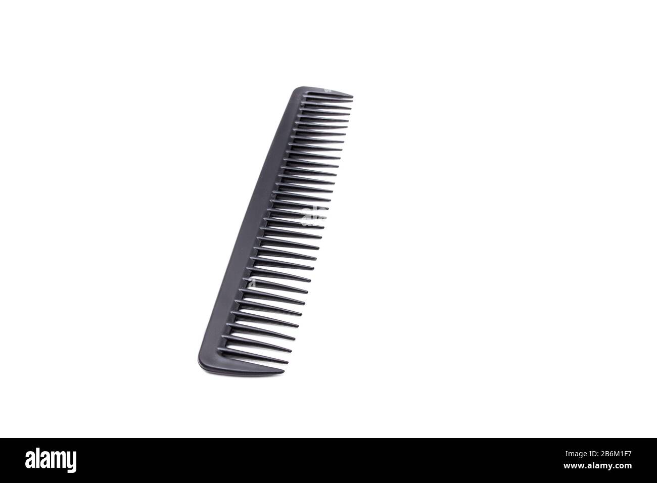 black barber comb on an isolated white background Stock Photo - Alamy