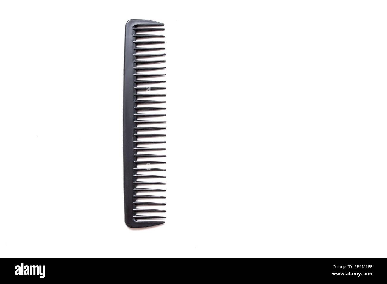 black barber comb on an isolated white background Stock Photo - Alamy