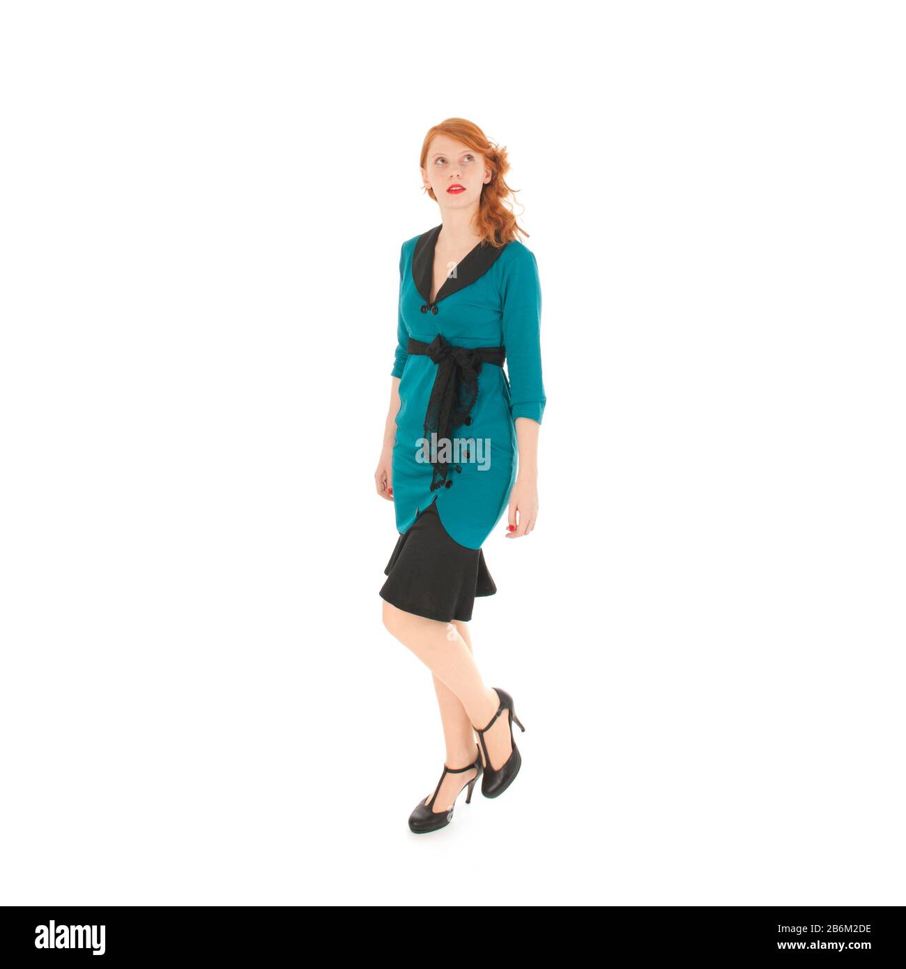 pretty woman formal dressed walking in studio isolated over white ...