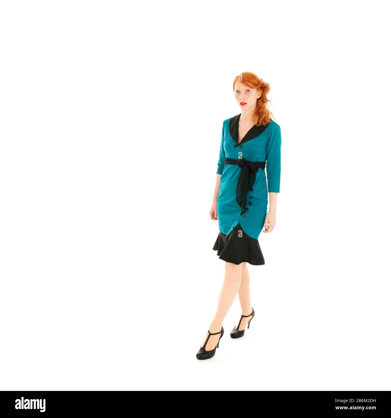 pretty woman formal dressed walking in studio isolated over white ...