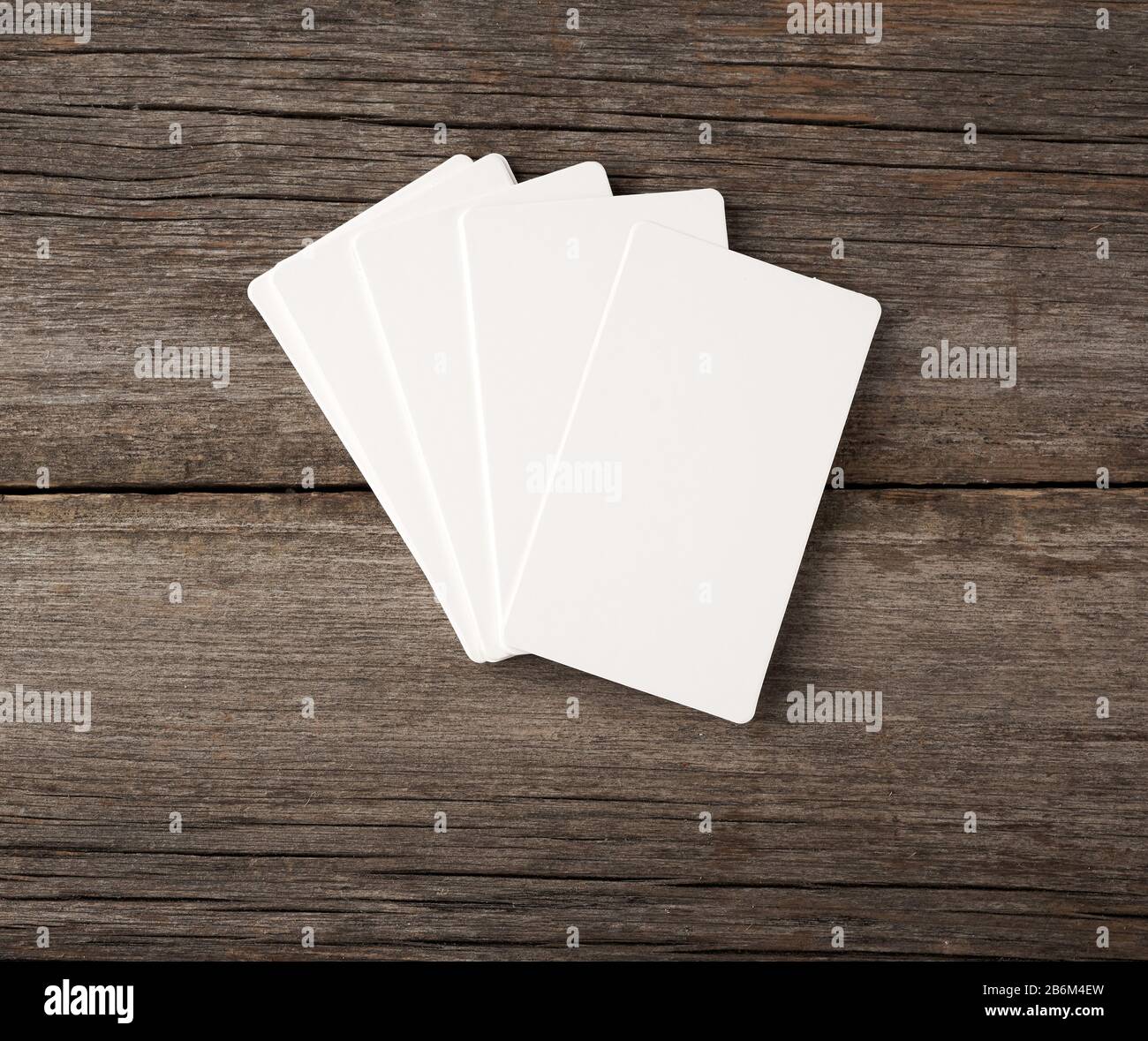 stack of rectangular white blank business cards on a gray wooden ...