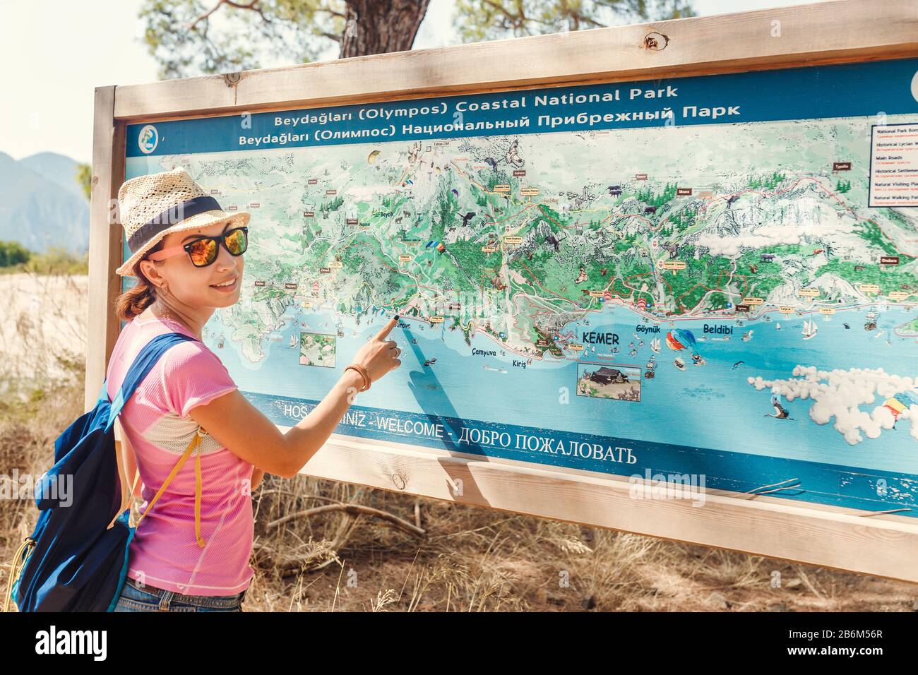 16 SEPTEMBER 2017, CIRALI, TURKEY: A young woman exploring the map of ...