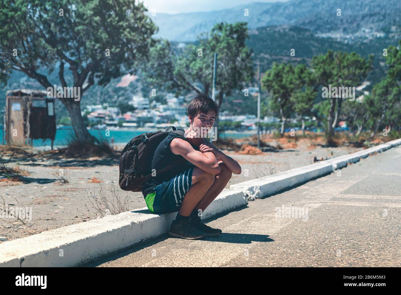Man sitting on curb hi-res stock photography and images - Alamy