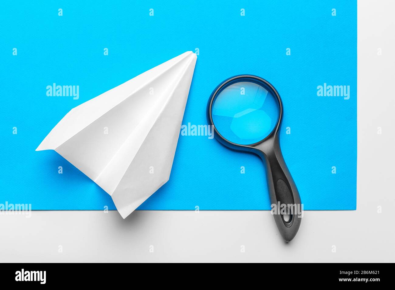 paper plane with office supplies on blue background Stock Photo - Alamy
