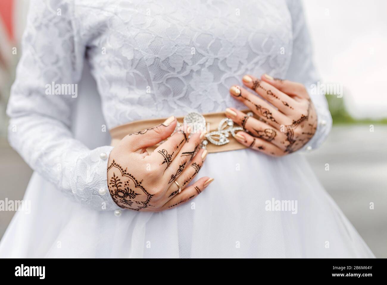 Close-up of hands decorated with a picture of a mehendi of a Muslim ...