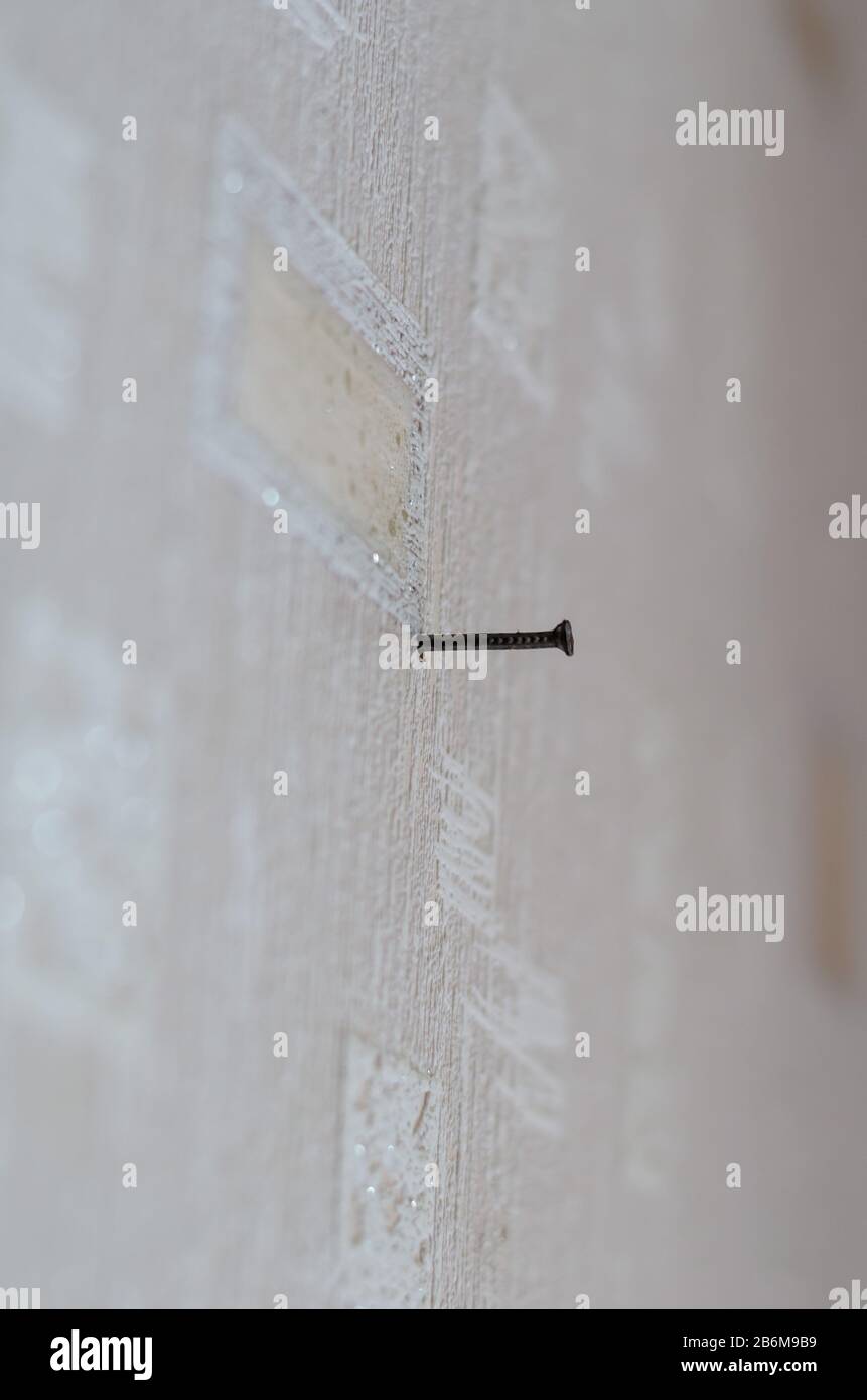 Rusty nail in stone hi-res stock photography and images - Alamy