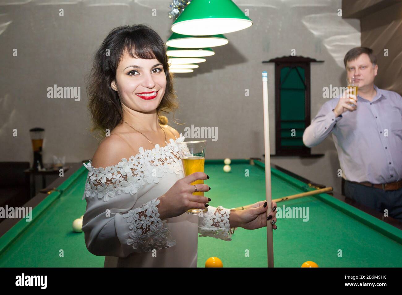 Drinking alcohol while playing billiards. Adult 30 year old lovers have ...