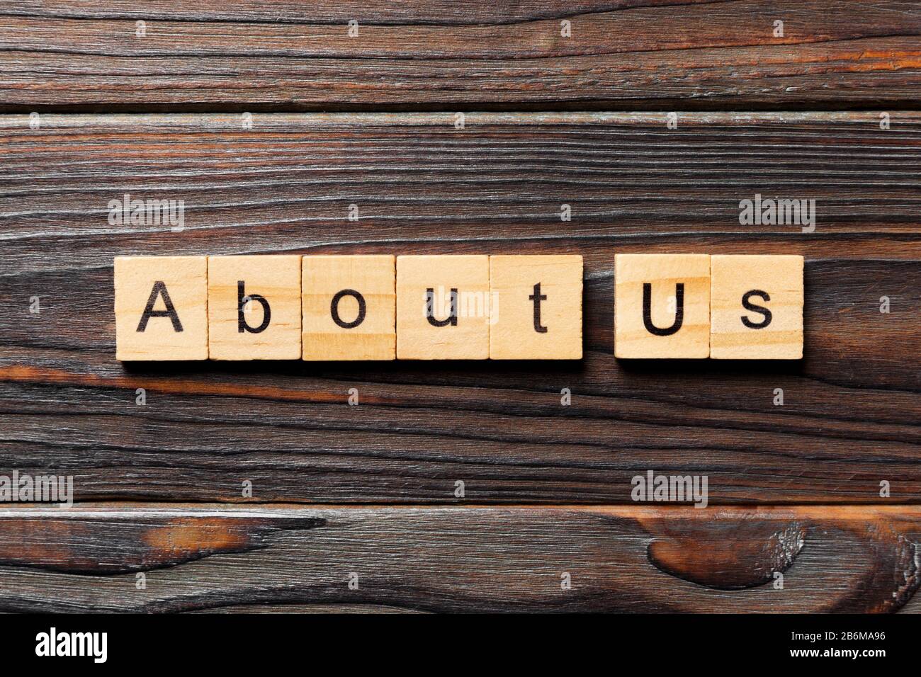 About us word written on wood block. About us text on wooden table for ...