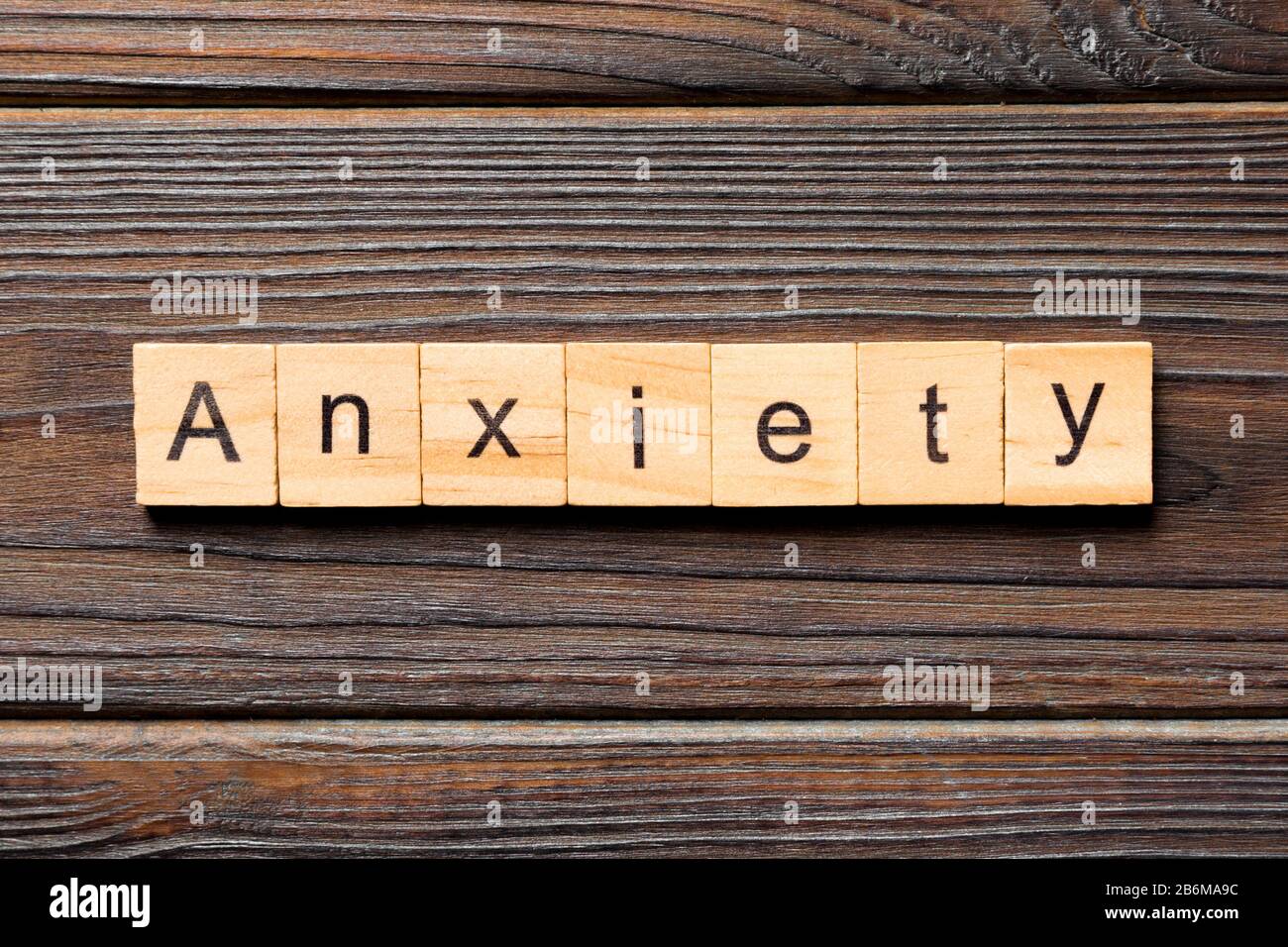 Anxiety word written on wood block. Anxiety text on wooden table for ...