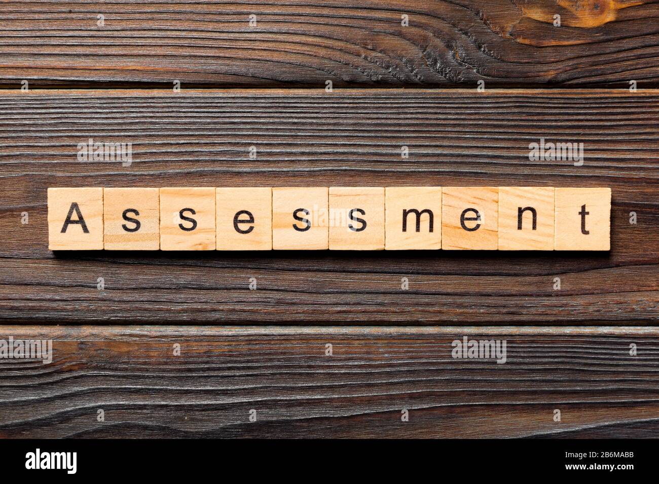 assessment word written on wood block. assessment text on table ...