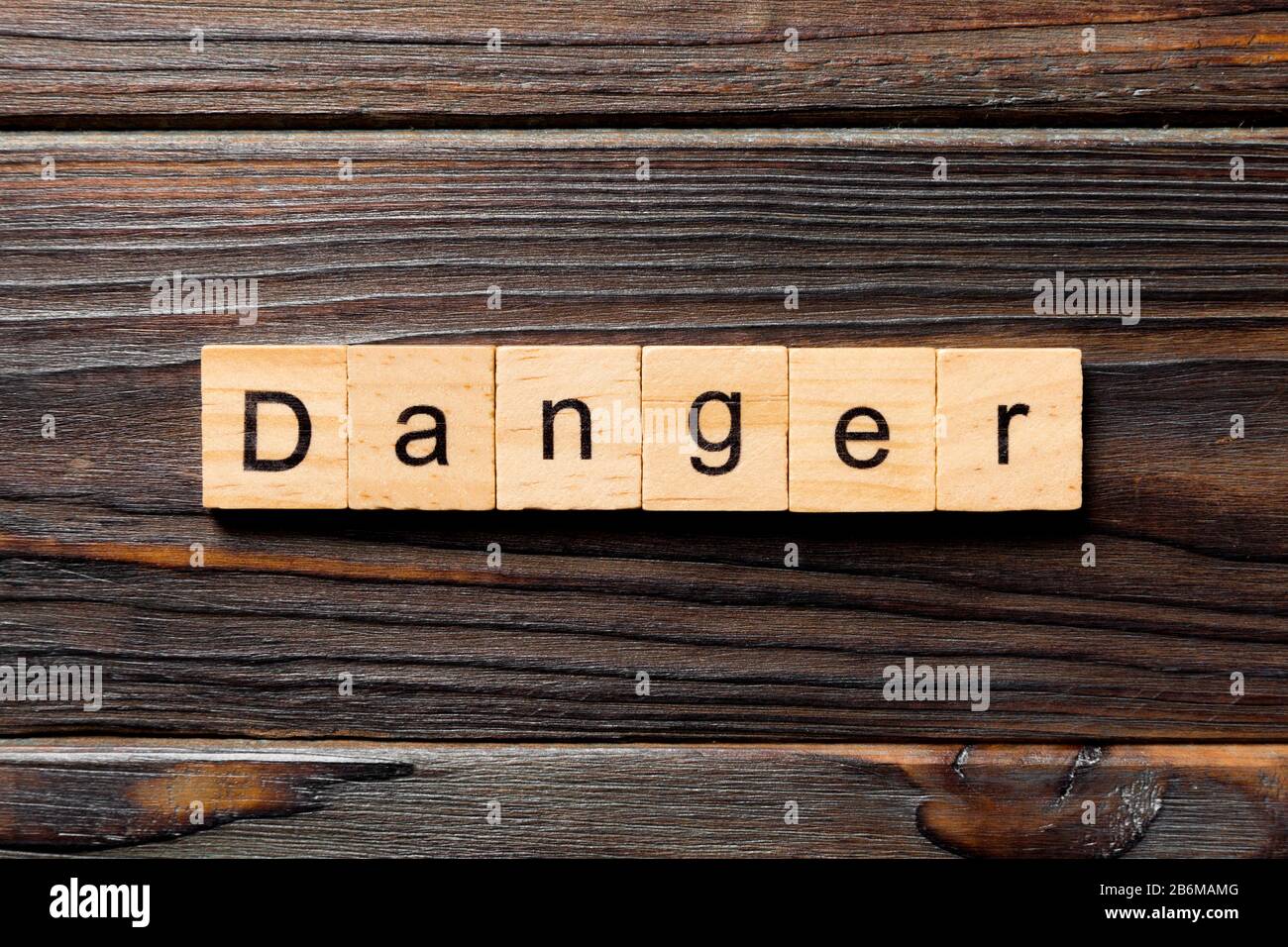 Danger word written on wood block. Danger text on wooden table for your ...