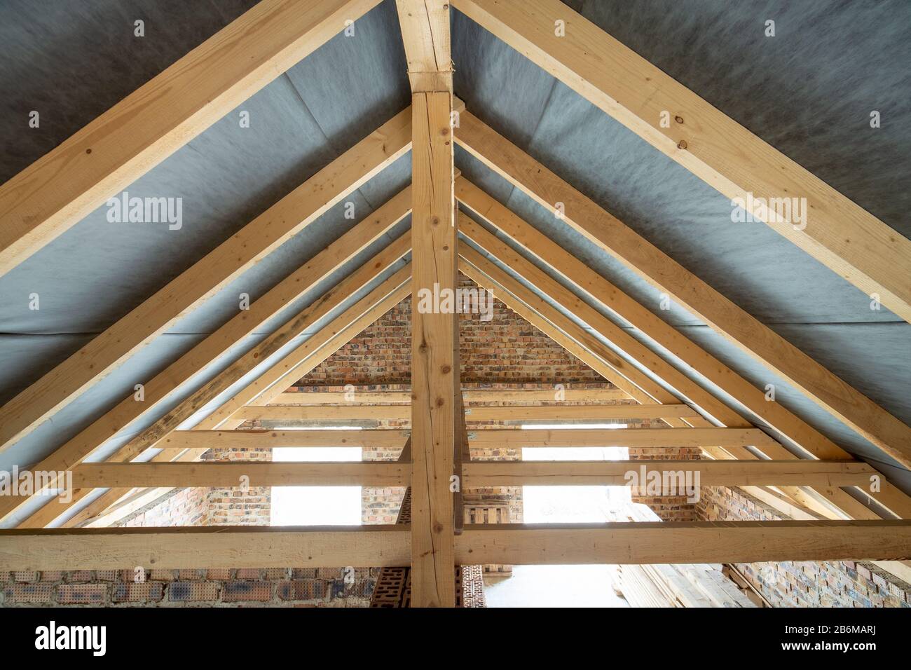 Attic space of a building under construction with wooden beams of a ...