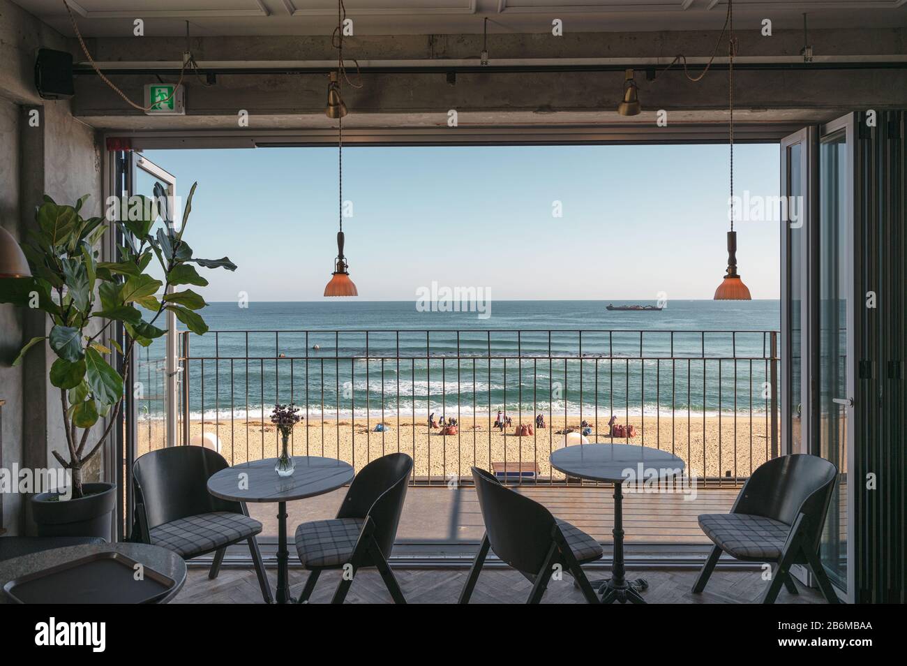 Table and chairs with wooden patio on the beach in tropical sea Stock ...