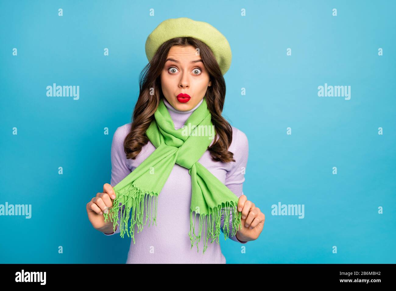 Photo of funky traveler lady holding scarf hands not sure about style ...