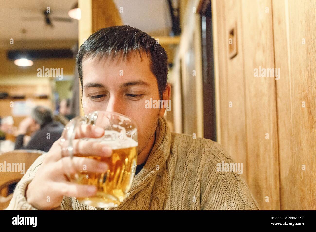 Man sitting in a pub drinking a pint of beer hi-res stock photography ...
