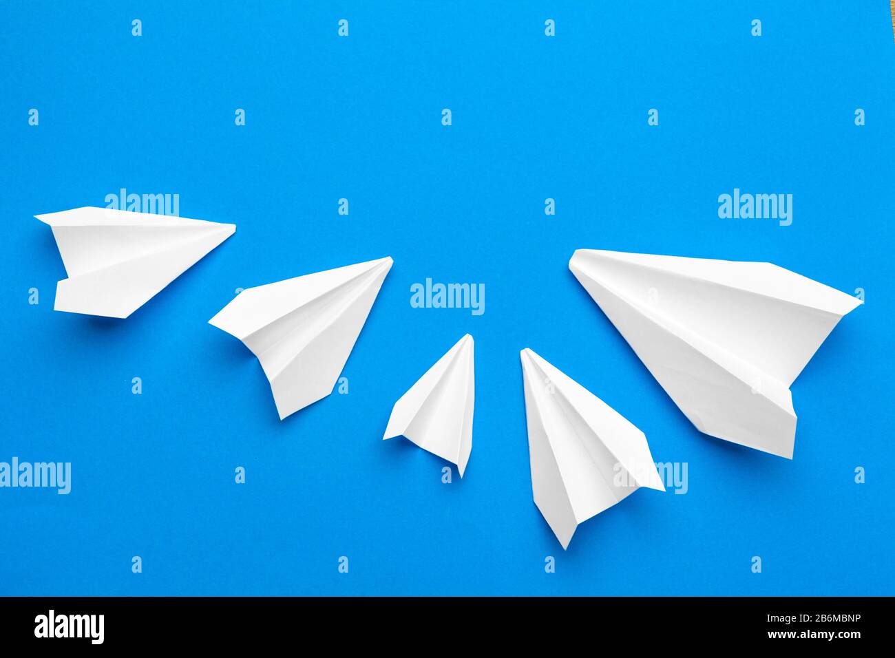 white paper airplane on a navy paper background Stock Photo - Alamy