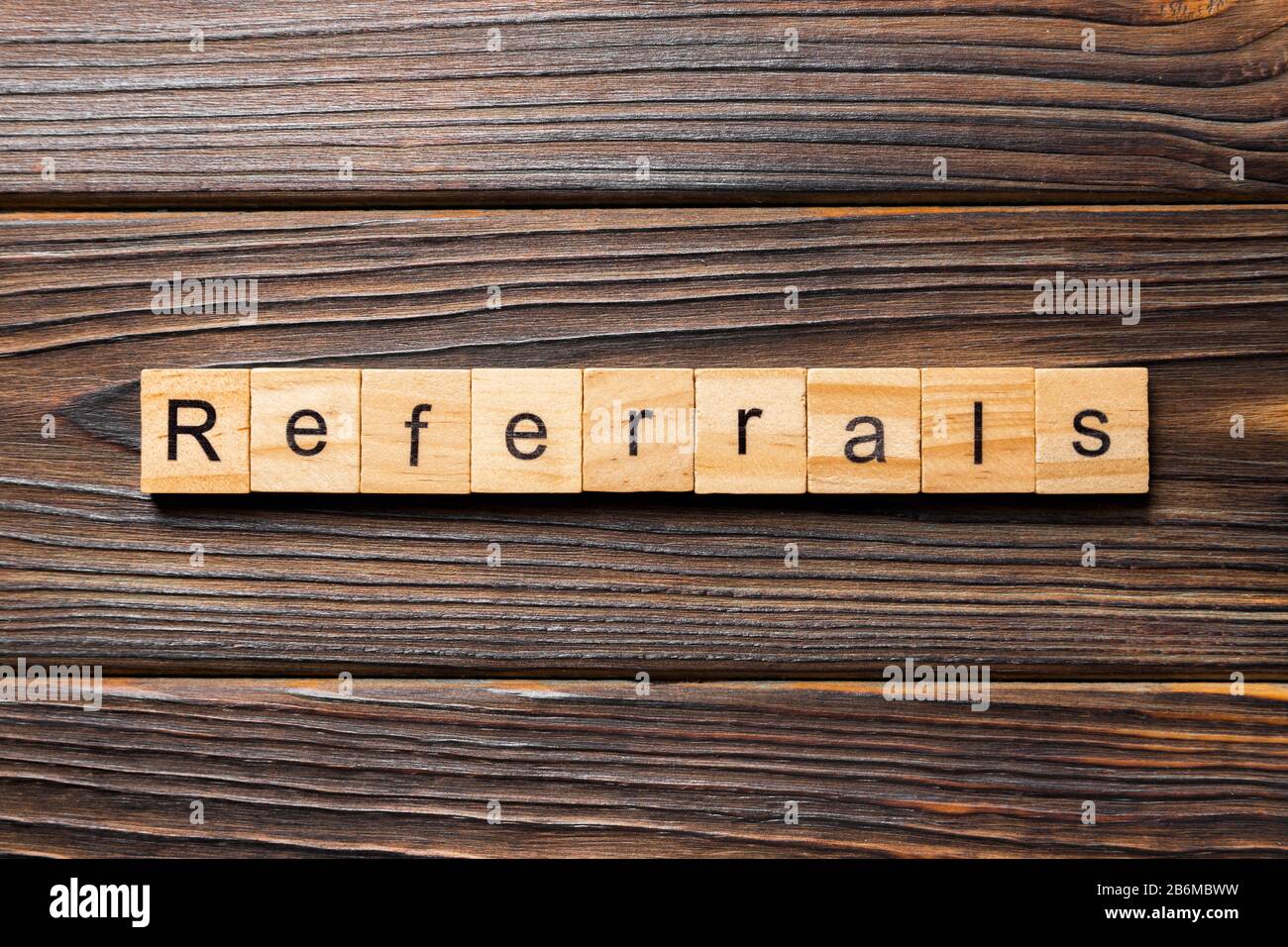 REFERRALS word written on wood block. REFERRALS text on wooden table ...