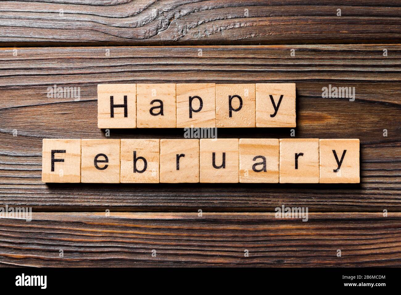 Happy February word written on wood block. Happy February text on table ...