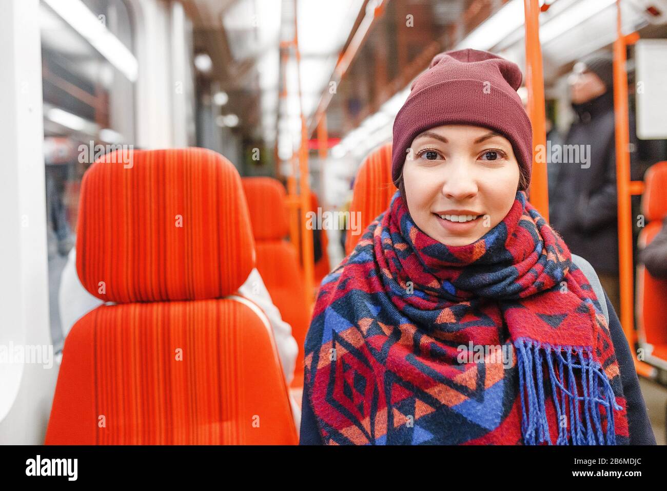 beautiful young woman sitting in metro train Stock Photo - Alamy