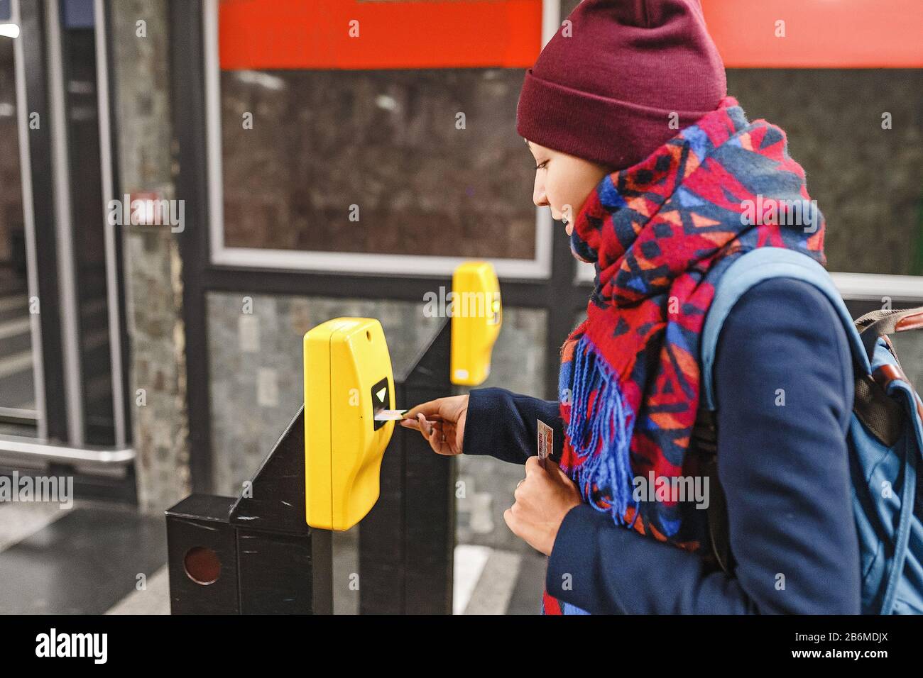 Woman validate ticket in validating machine device to entering at metro ...