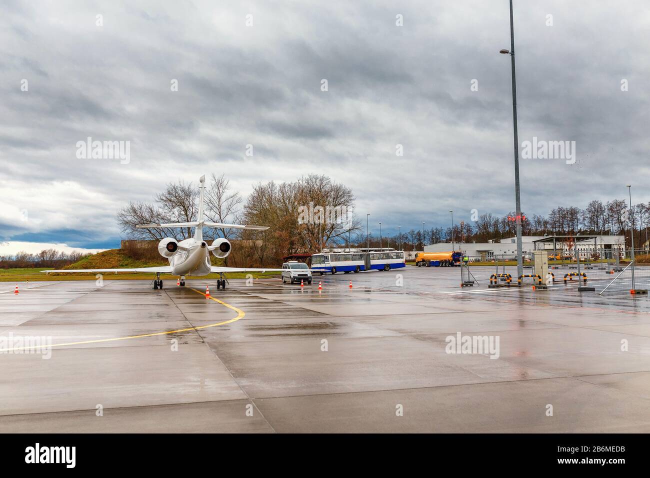 Jet airplane with service staff cars Stock Photo - Alamy