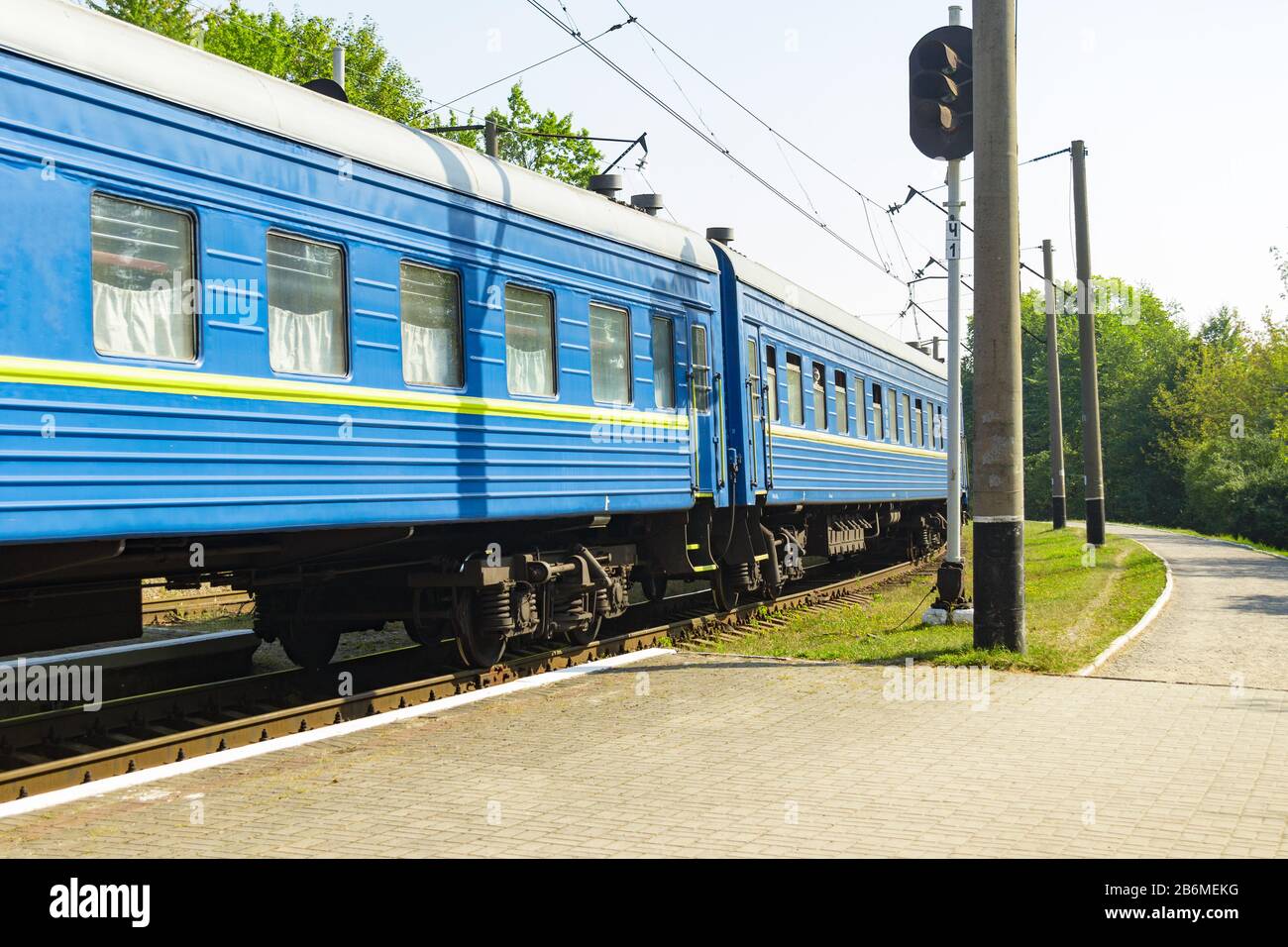 Old blue train is leaving the platfrom at the railway station Stock ...
