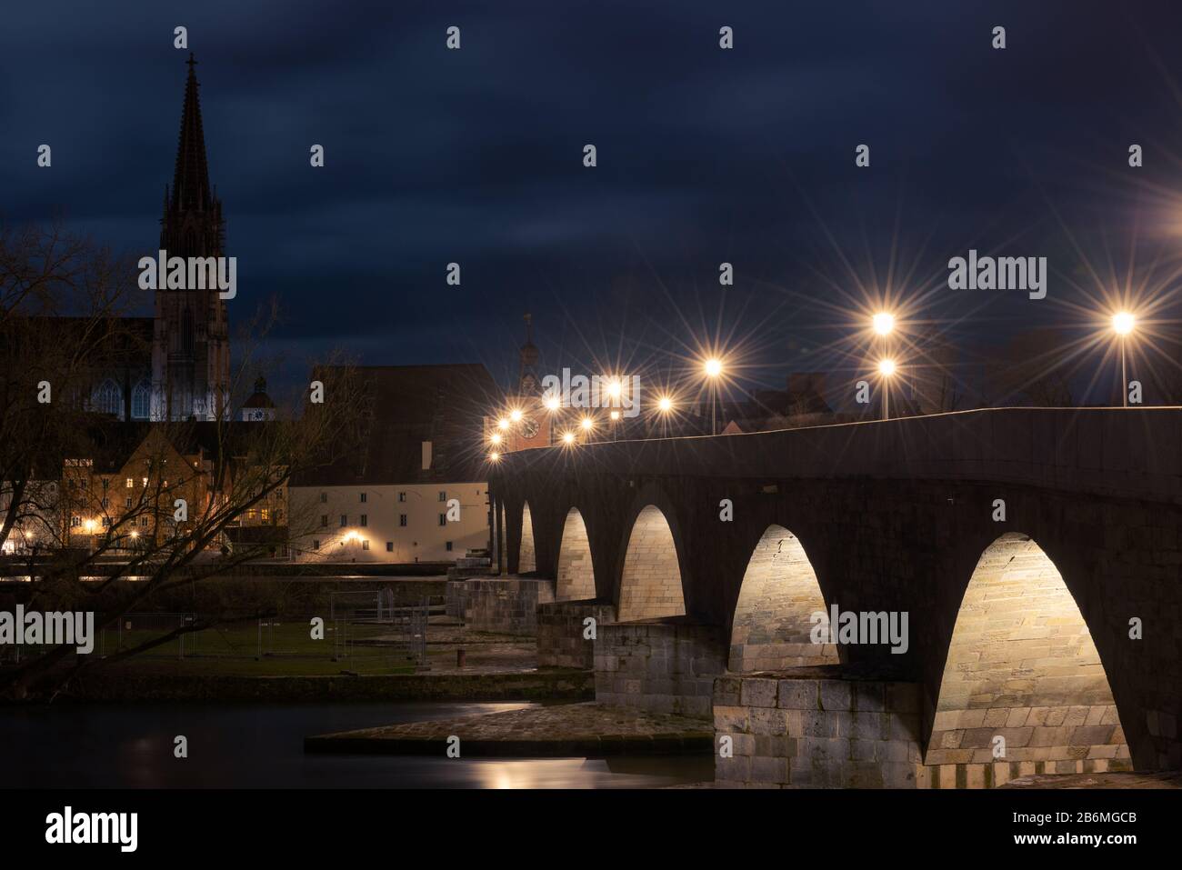 Historic illuminated stone bridge in Regensburg, Bavaria with cathedral ...