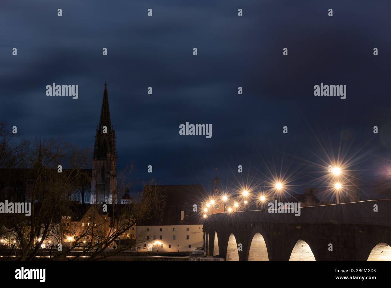 Historic illuminated stone bridge in Regensburg, Bavaria with cathedral ...