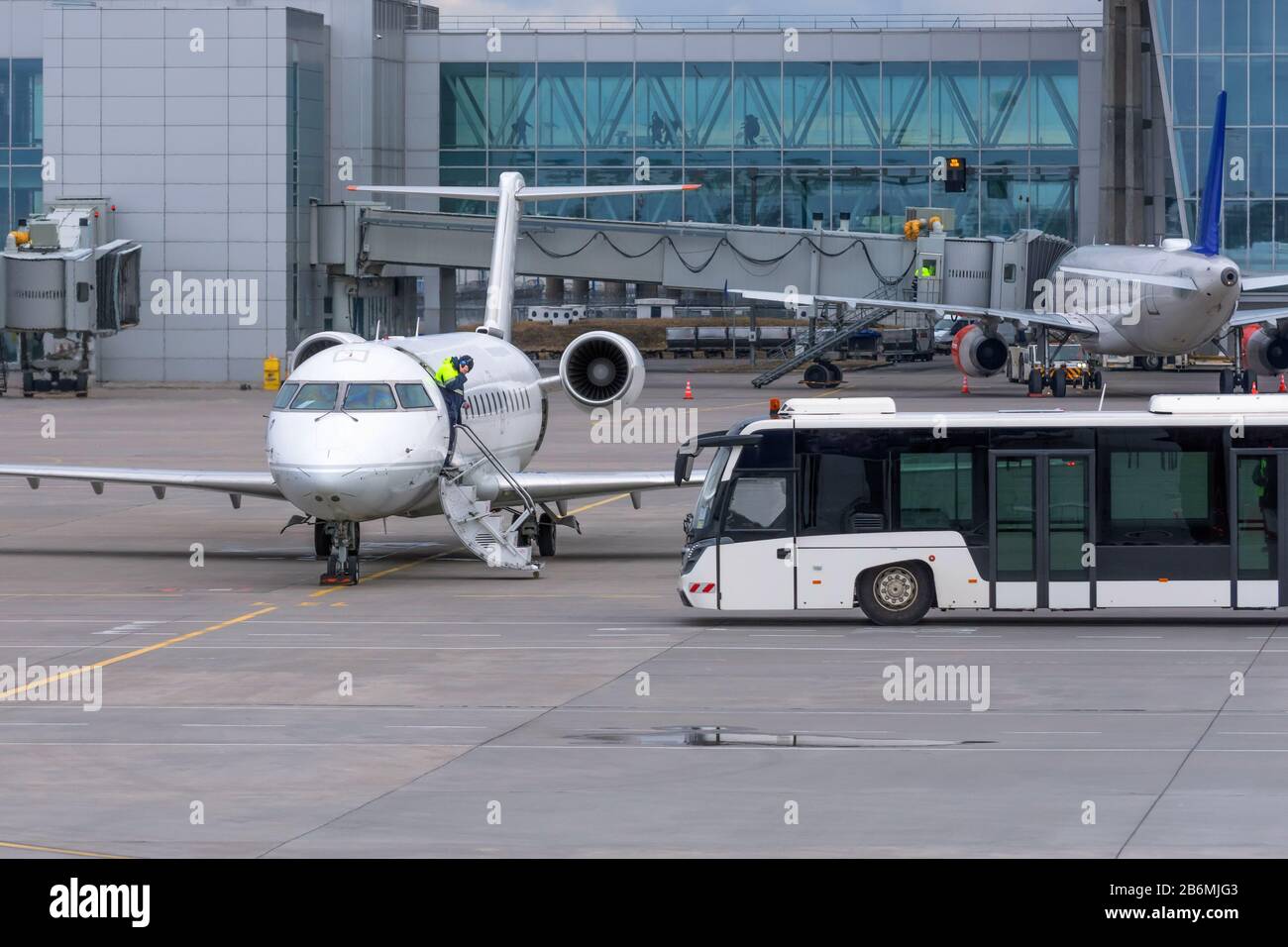 Airport bus stop at the parking of the aircraft waiting for passengers ...