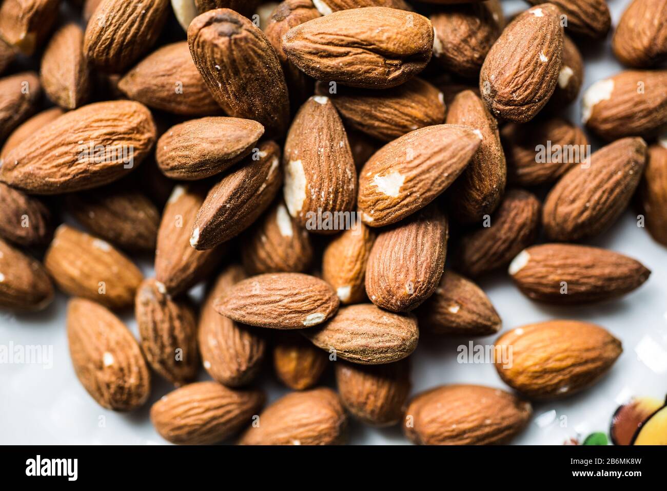 Almond kernels with husk in a heap Stock Photo - Alamy