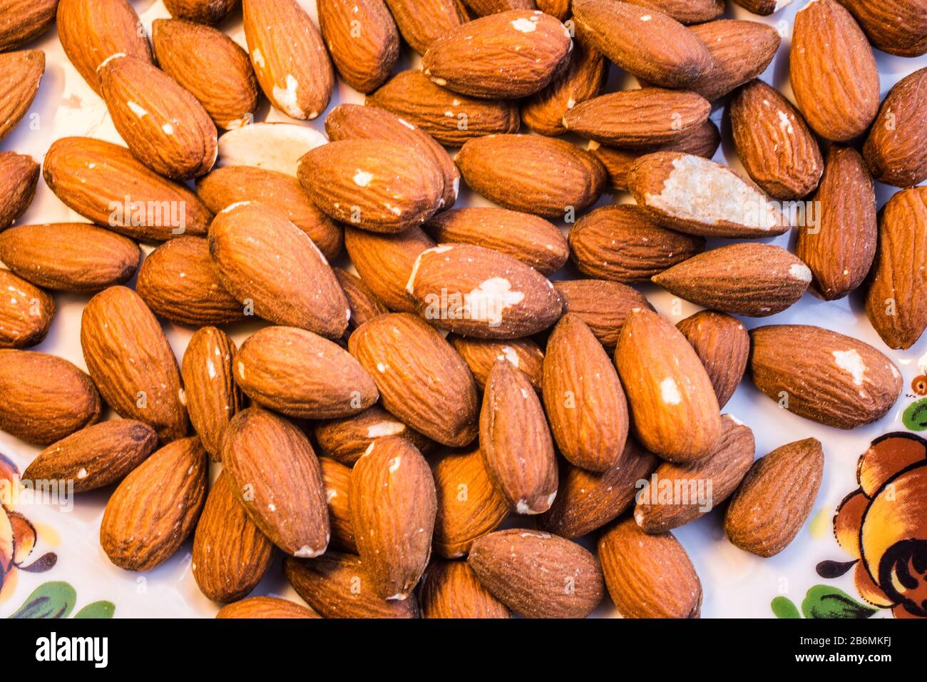 Almond kernels with husk in a heap Stock Photo - Alamy