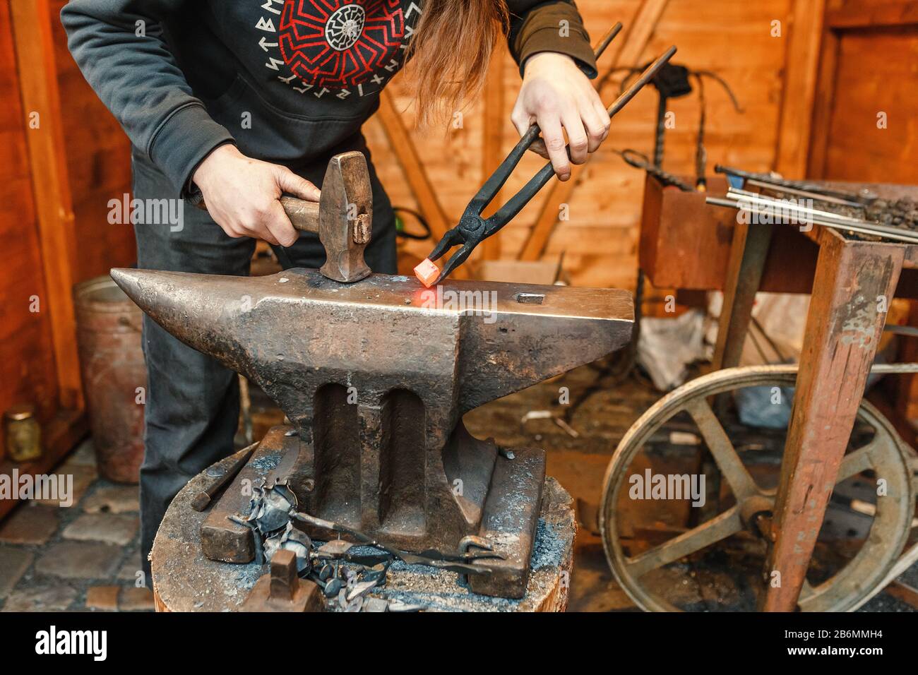 blacksmith working with hot metal at fair Stock Photo - Alamy