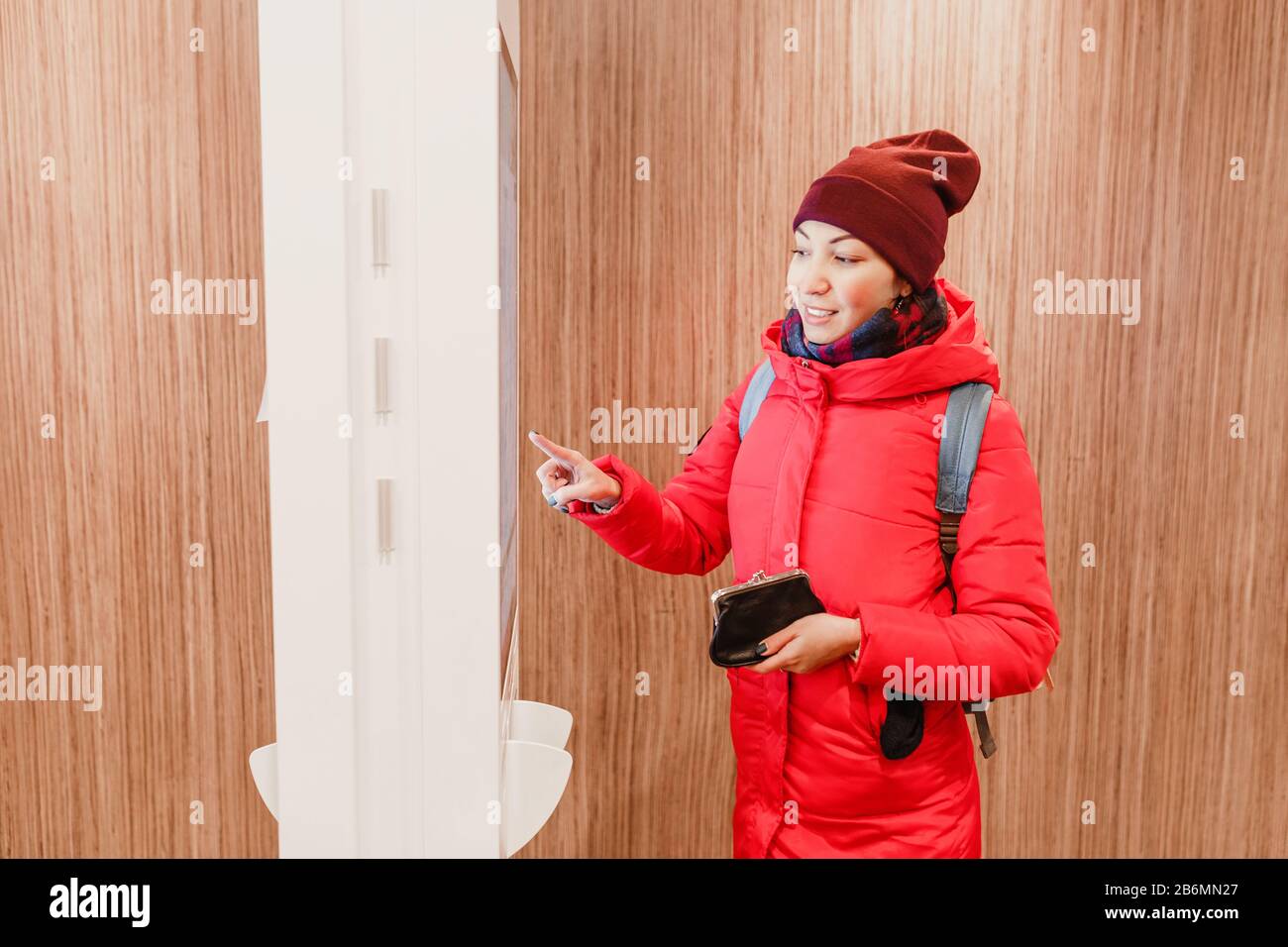 A woman orders meal in the touch screen terminal in the electronic menu ...