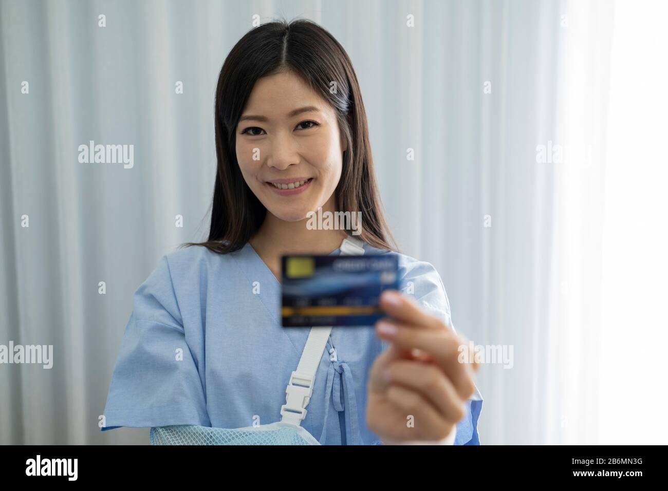 Young asian female patients show their credit cards separately on a ...