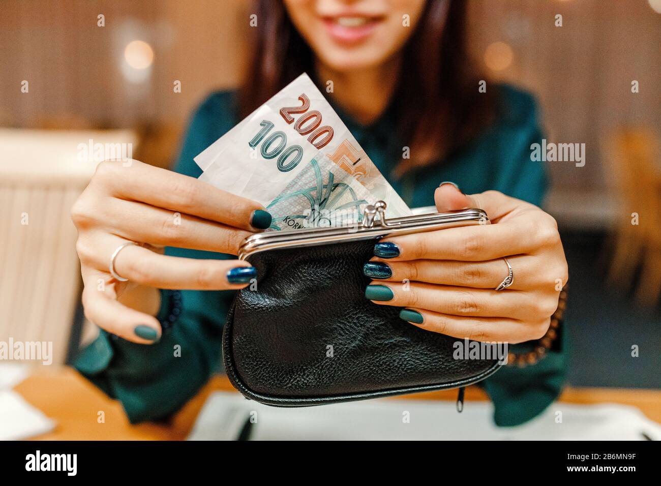 customer woman in the restaurant after dinner gets money out of her ...