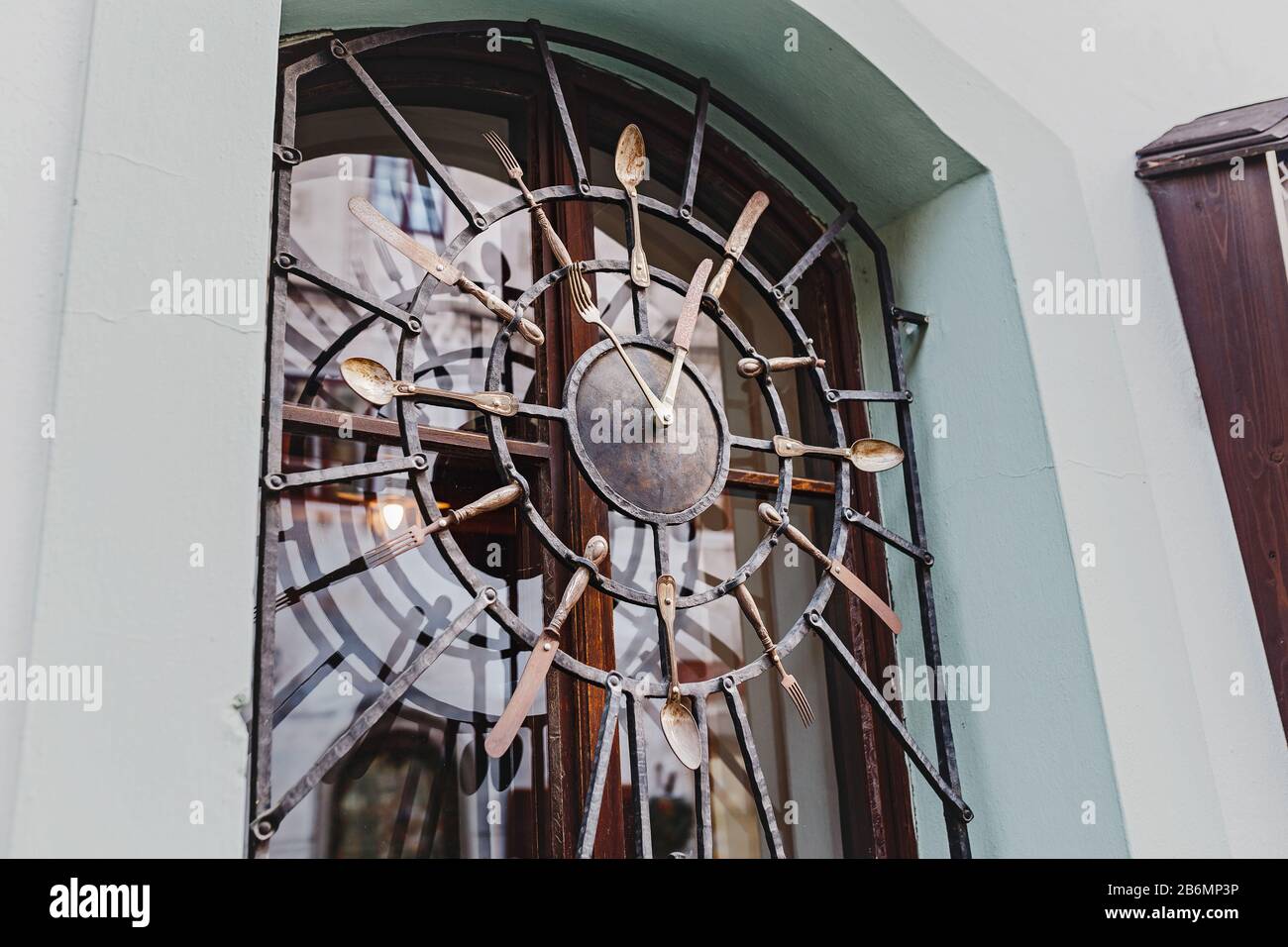 Clock made from vintage cutlery at the entrance to the restaurant Stock ...