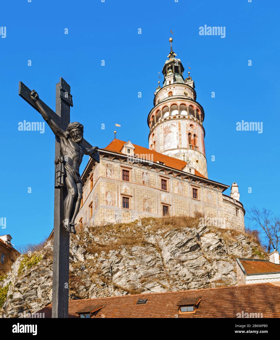 statue of Jesus Christ crucifixion in Cesky Krumlov at the background ...