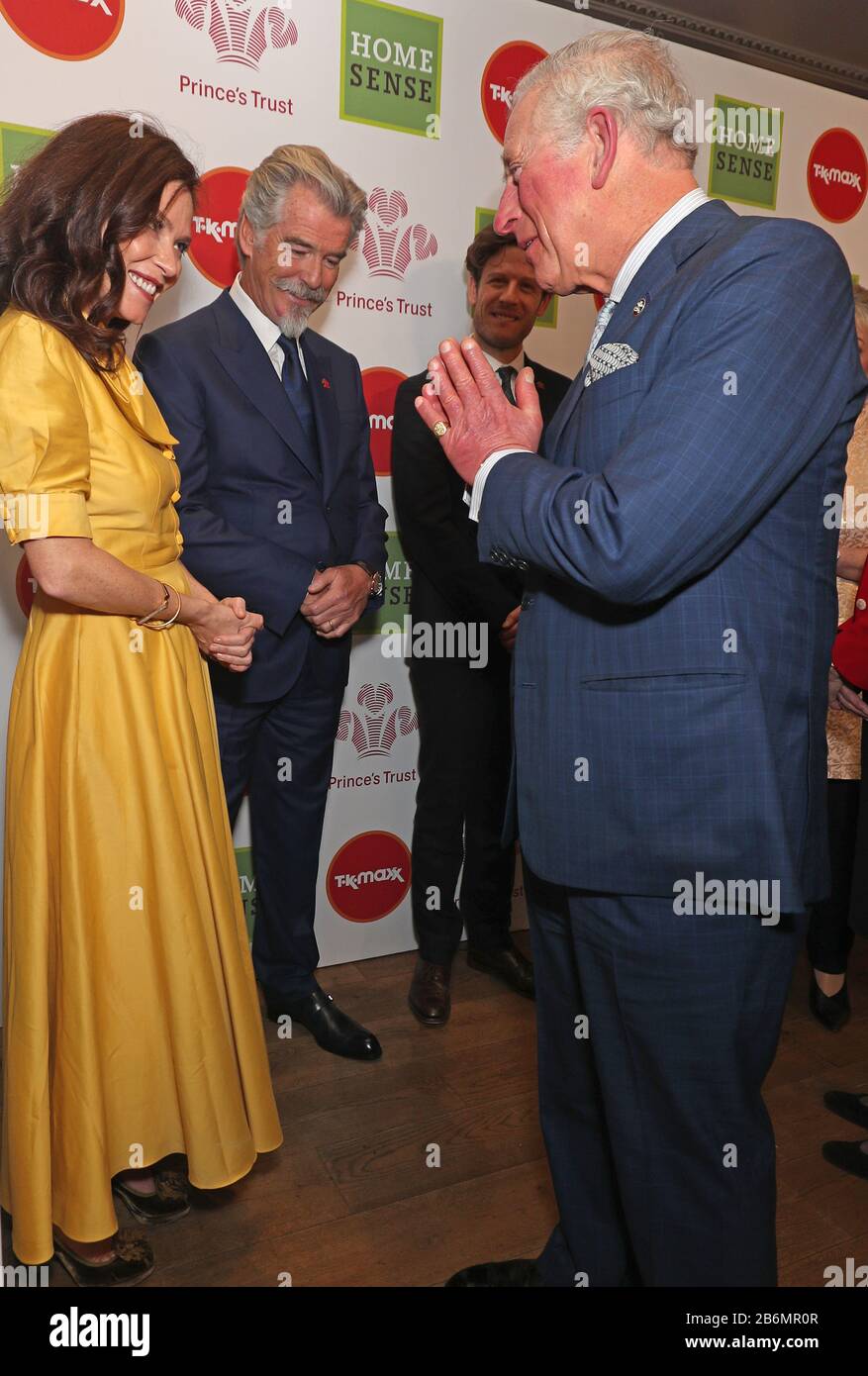 The Prince of Wales greets Anna Friel and Pierce Brosnan with a Namaste ...