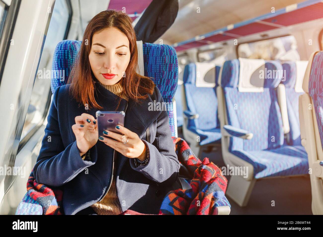a woman is traveling on a train in a first class cabin Stock Photo - Alamy