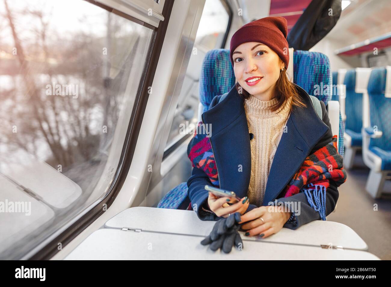 a woman is traveling on a train in a first class cabin Stock Photo - Alamy