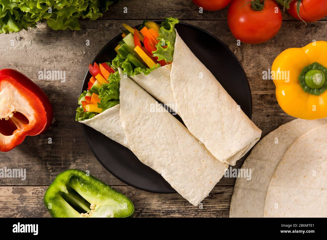 Vegetable tortilla wraps on wooden table. Top view Stock Photo - Alamy