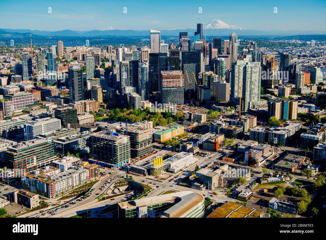 Aerial view of city of Seattle with Mount Rainier in background ...
