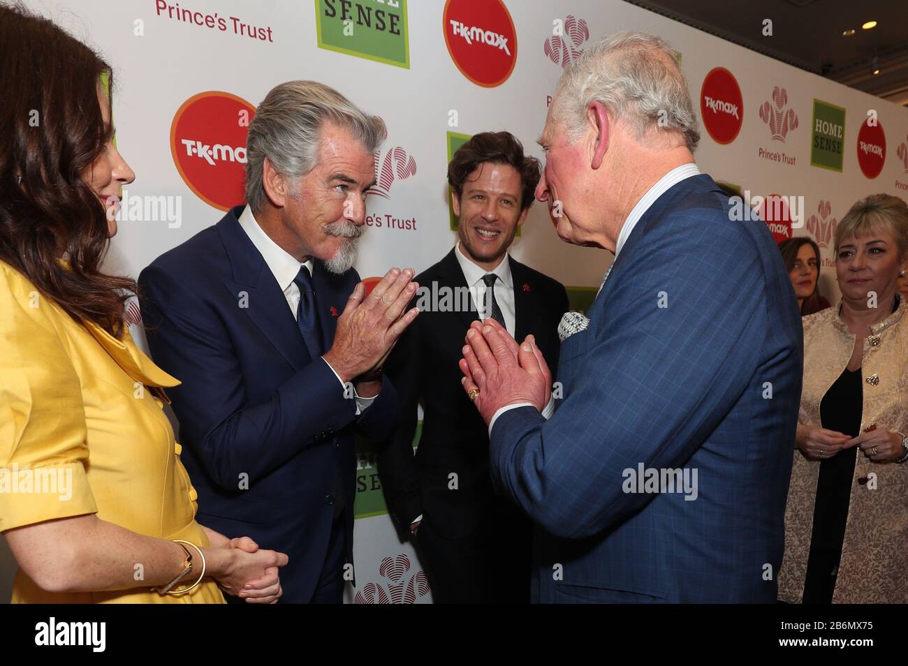 The Prince of Wales greets Pierce Brosnan with a Namaste gesture as he ...