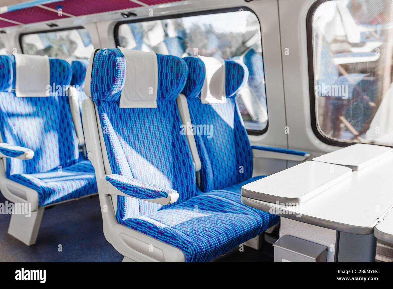 Empty seats in a luxury speed train with table Stock Photo - Alamy