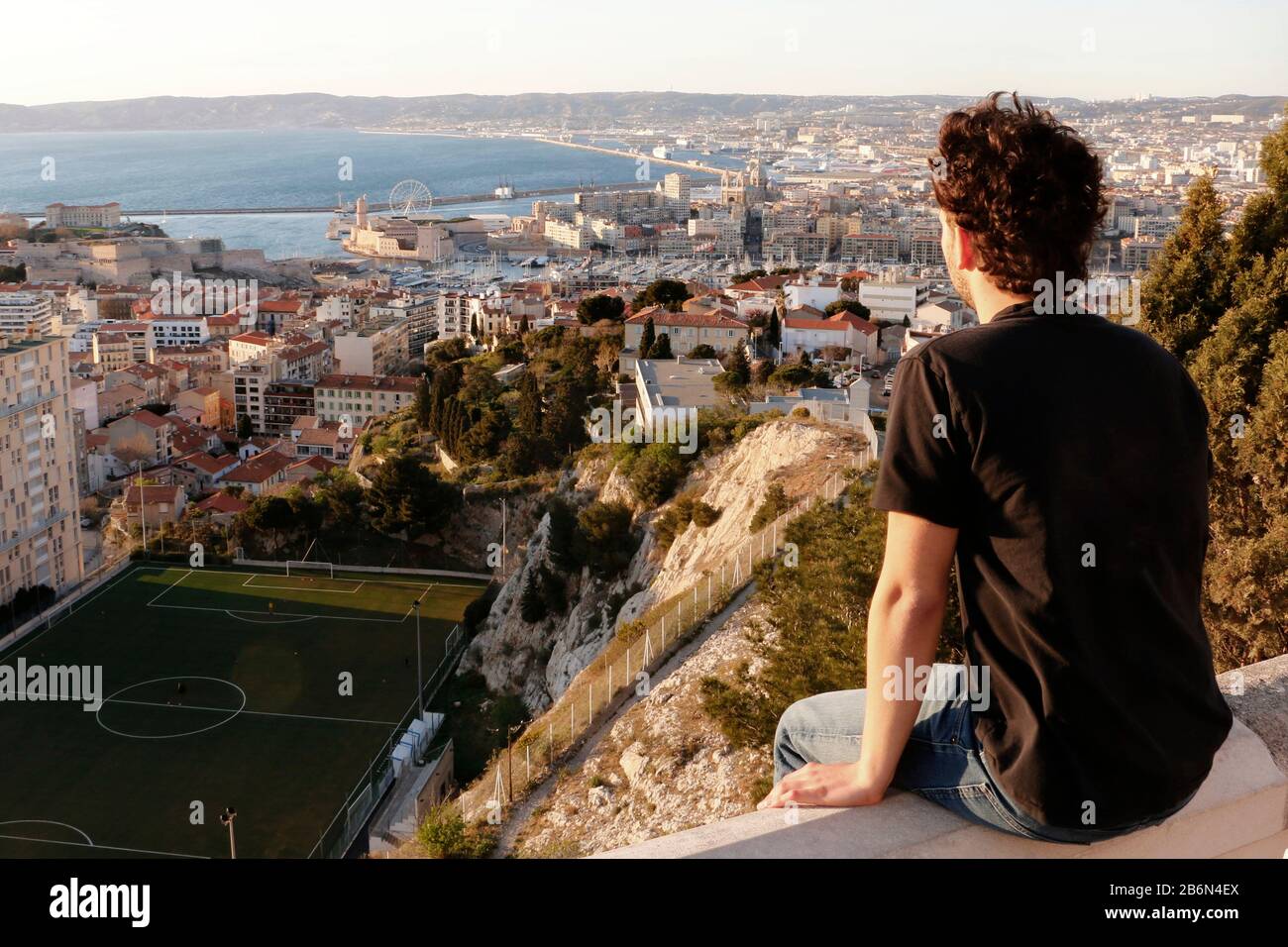 Male model sitting above Marseille and enjoying the view Stock Photo ...