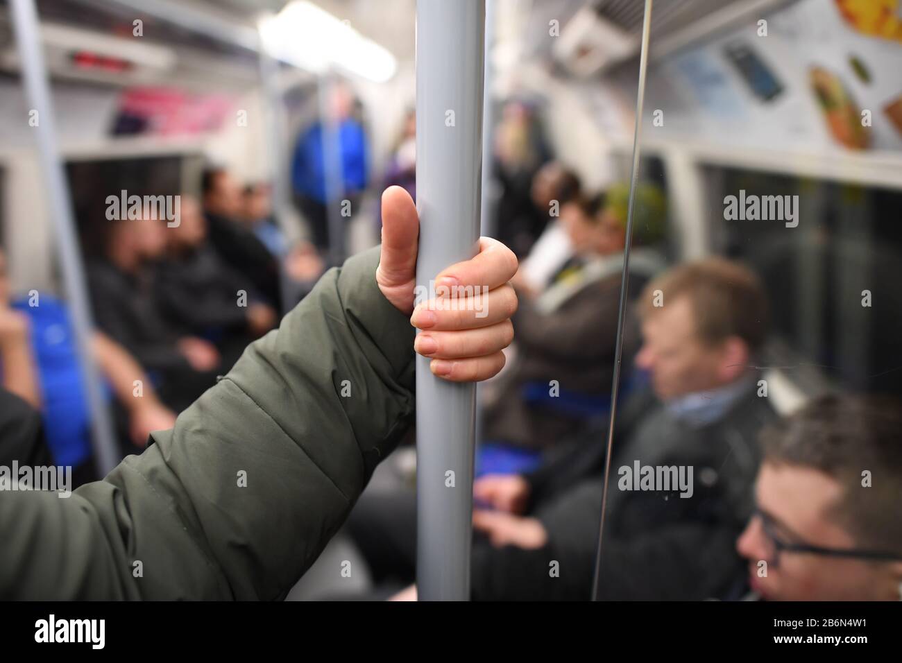 A picture posed by a model of a person holding the handrail on a London ...